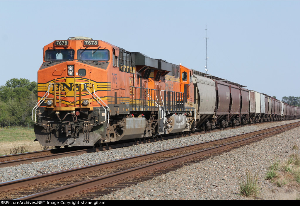 BNSF 7678 and 7043 work dpu on this eb grain train.